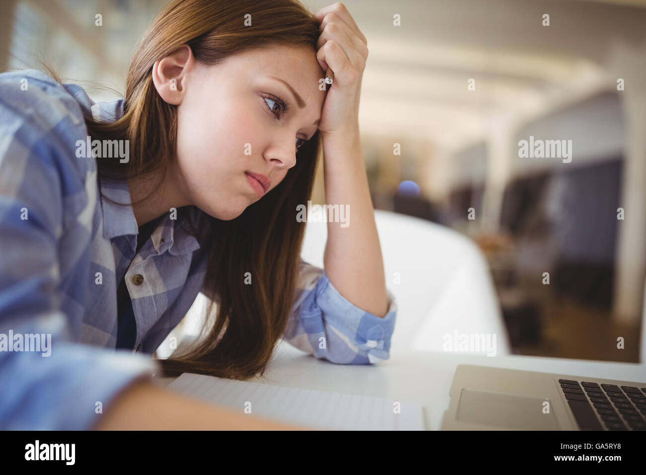 Stressed businesswoman with head in hand in office Stock Photo - Alamy