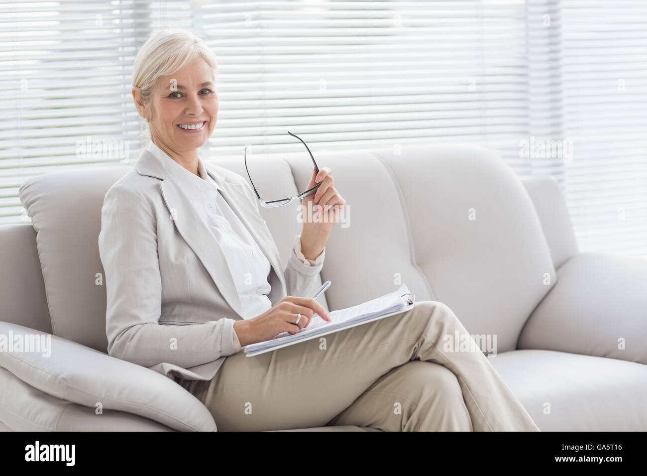 Portrait of happy therapist in office Stock Photo - Alamy