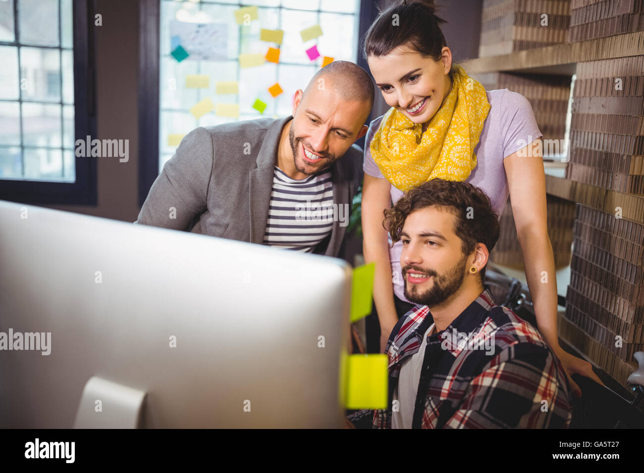 Business people looking at computer Stock Photo - Alamy