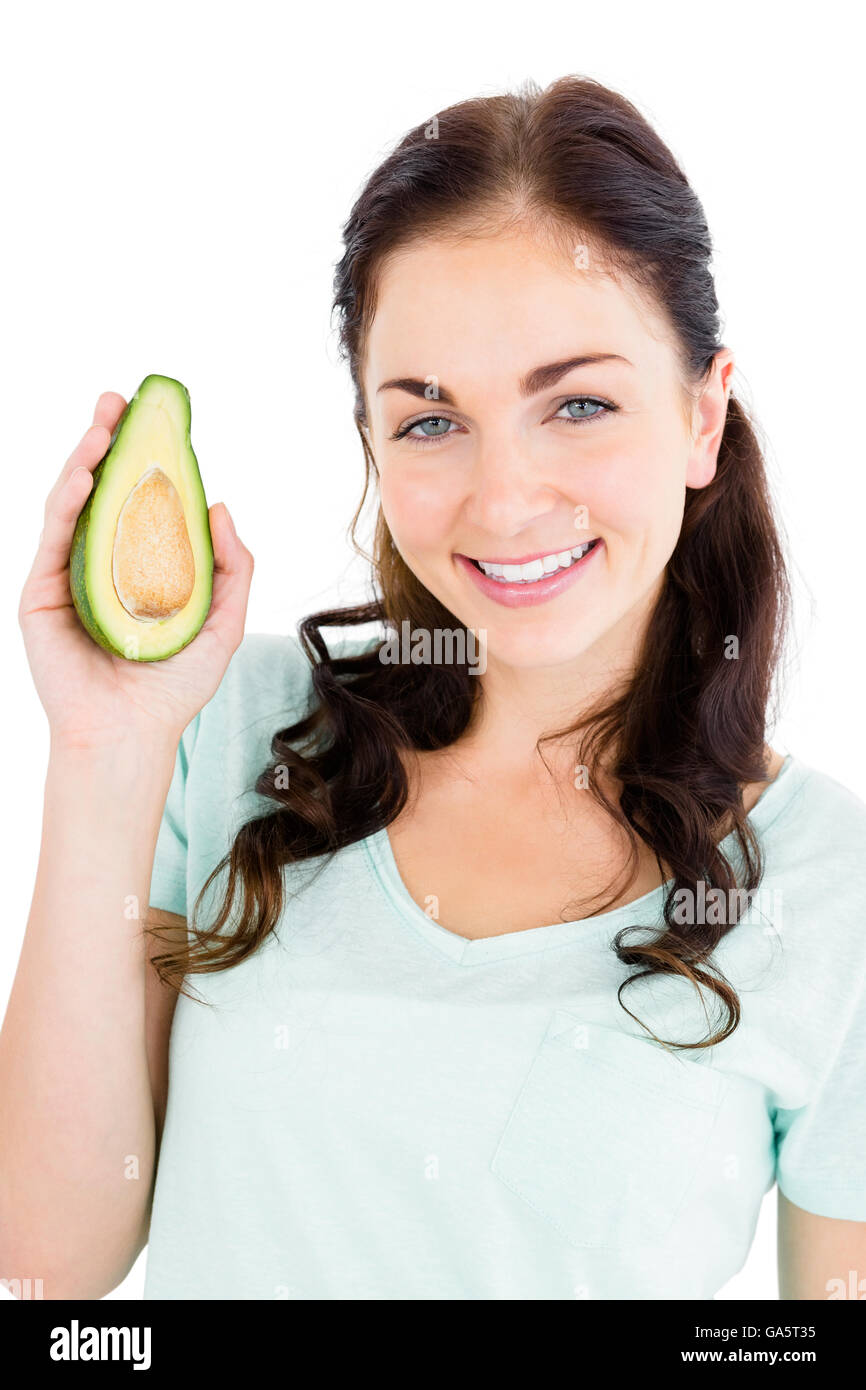 Portrait of cheerful woman holding avocado Stock Photo - Alamy