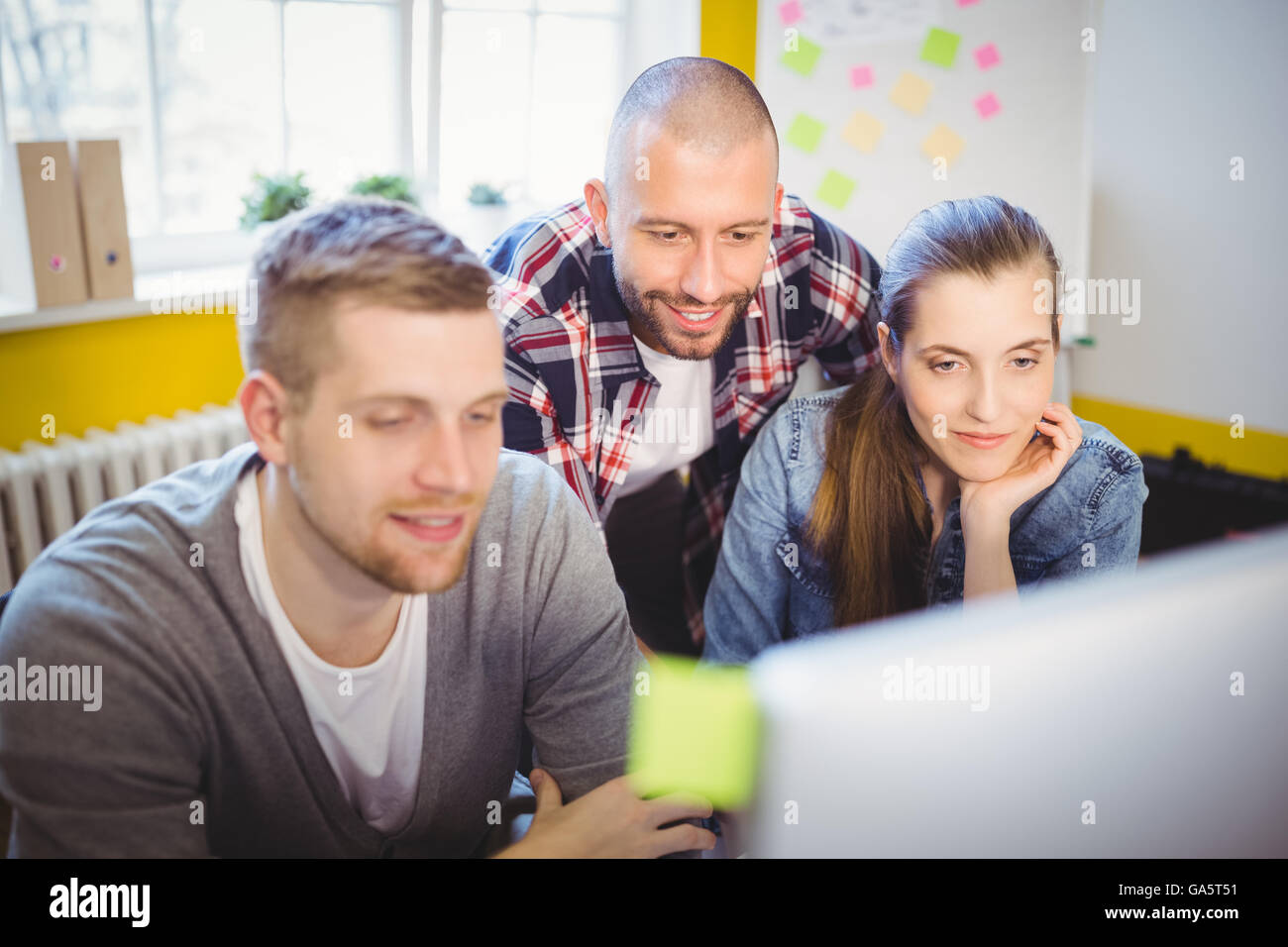 Business people looking at computer in office Stock Photo - Alamy