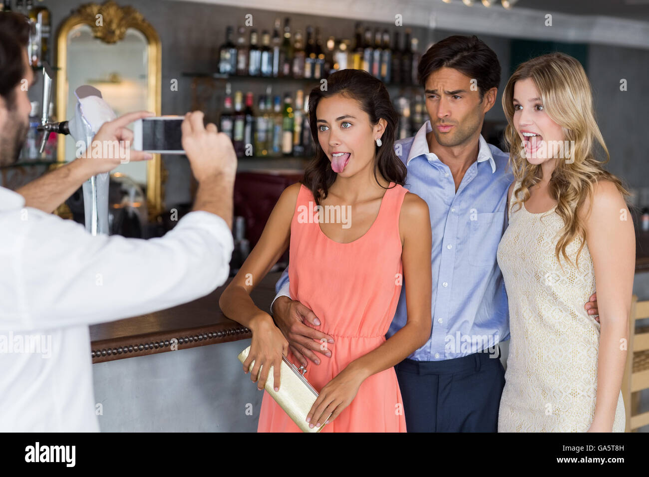 Man taking photo of his friends Stock Photo - Alamy