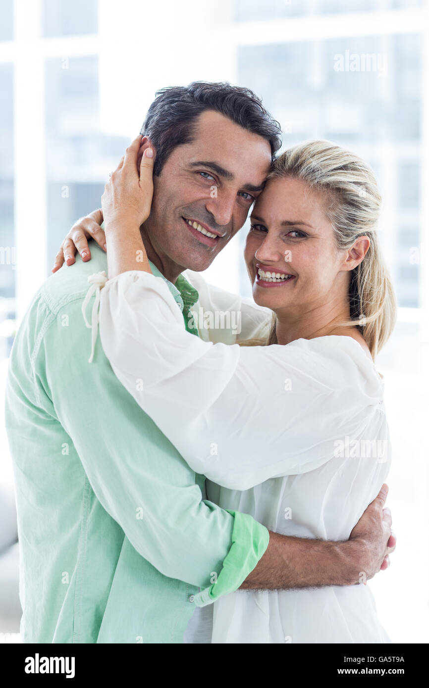 Portrait of romantic couple embracing at home Stock Photo - Alamy