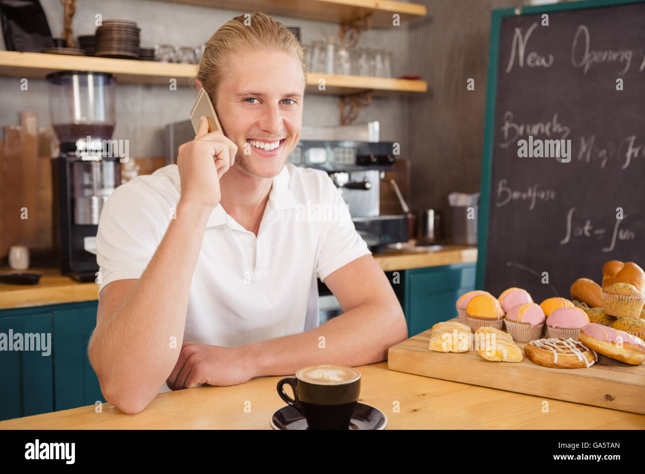 Waiter talking on mobile phone Stock Photo - Alamy