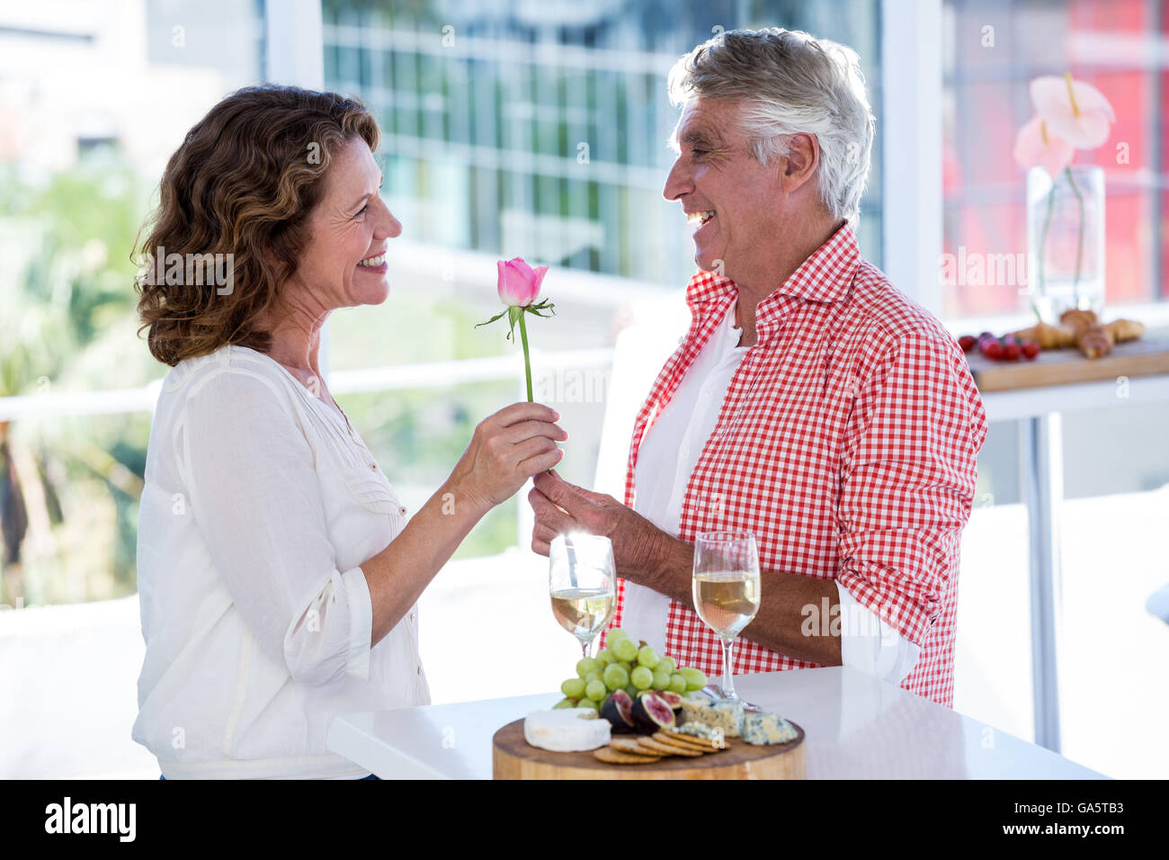 Man giving flower to woman Stock Photo - Alamy