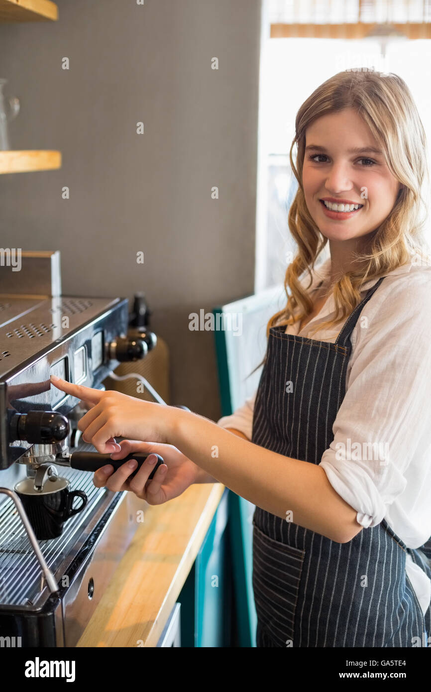 Portrait of smiling waitress making cup of coffee Stock Photo - Alamy