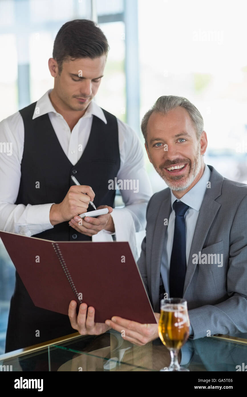 Waiter taking the order from a businessman Stock Photo - Alamy