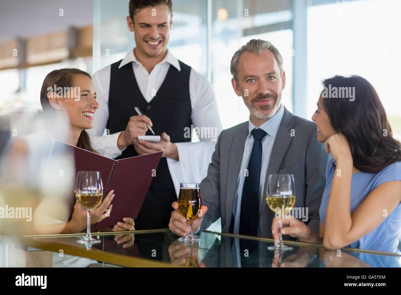 Woman restaurant ordering food waiter hi-res stock photography and ...