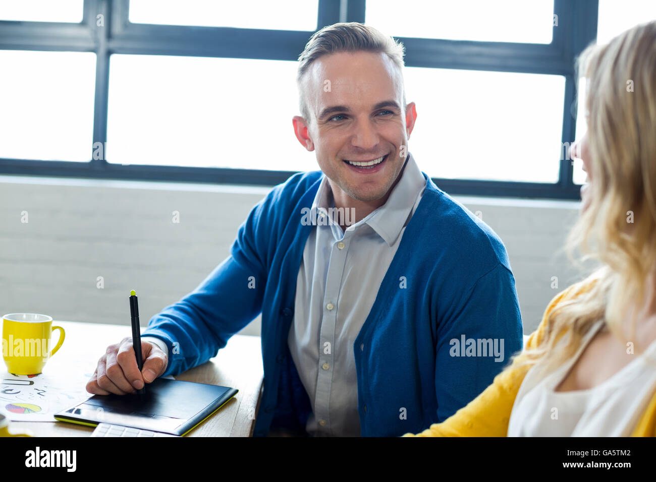 Male colleagues sitting talking in hi-res stock photography and images - Alamy