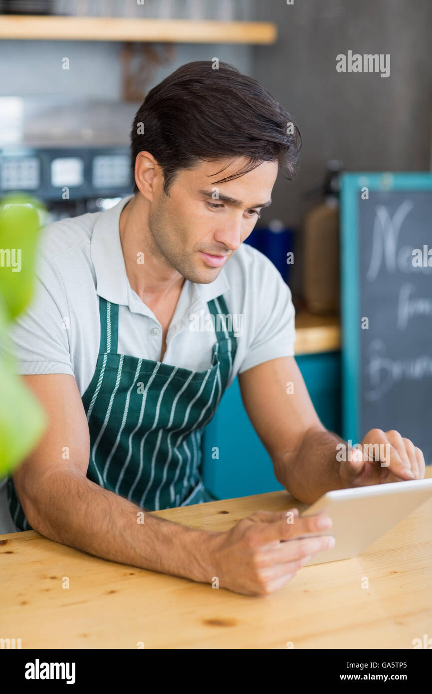 Waiter using digital tablet Stock Photo - Alamy