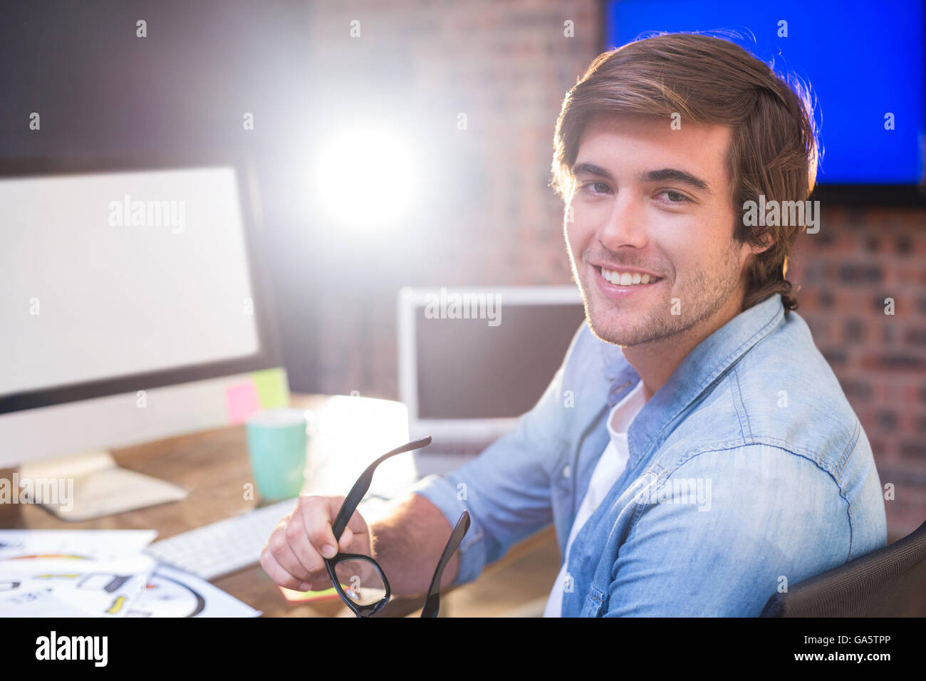 Young businessman at desk in office Stock Photo - Alamy