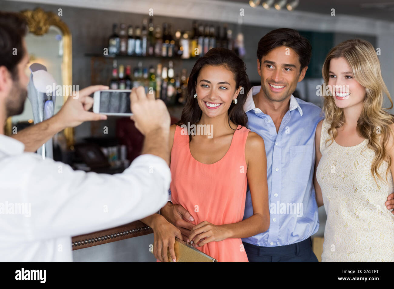 Man taking photo of his friends Stock Photo - Alamy