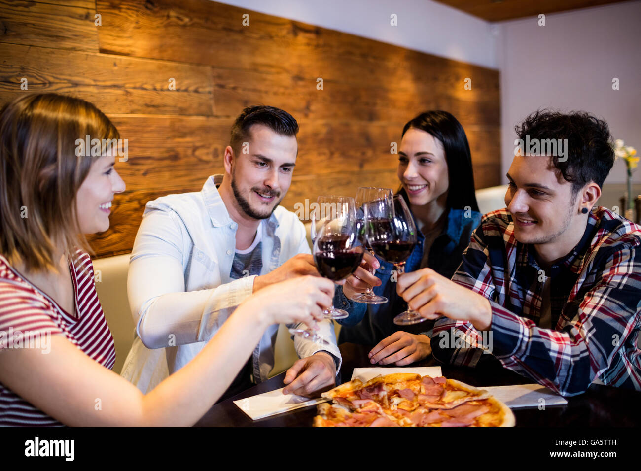 Friends toasting wine at table Stock Photo - Alamy
