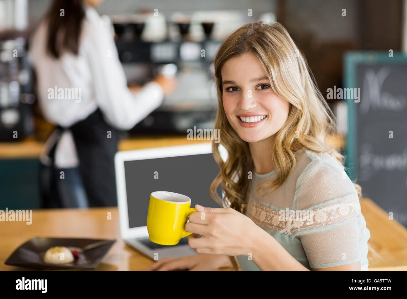 Portrait of smiling woman having cup of coffee Stock Photo - Alamy