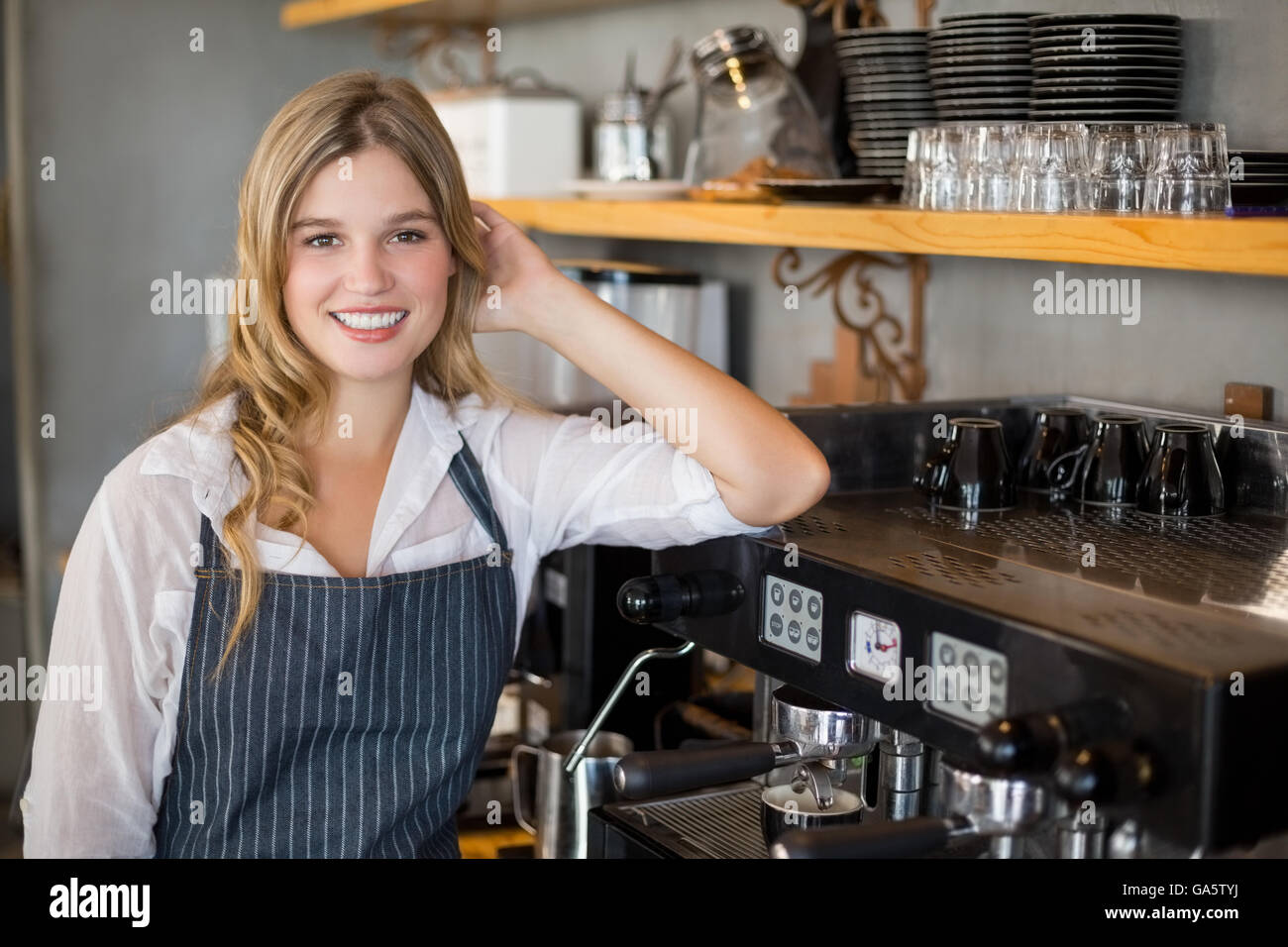 Portrait of smiling waitress making cup of coffee Stock Photo - Alamy