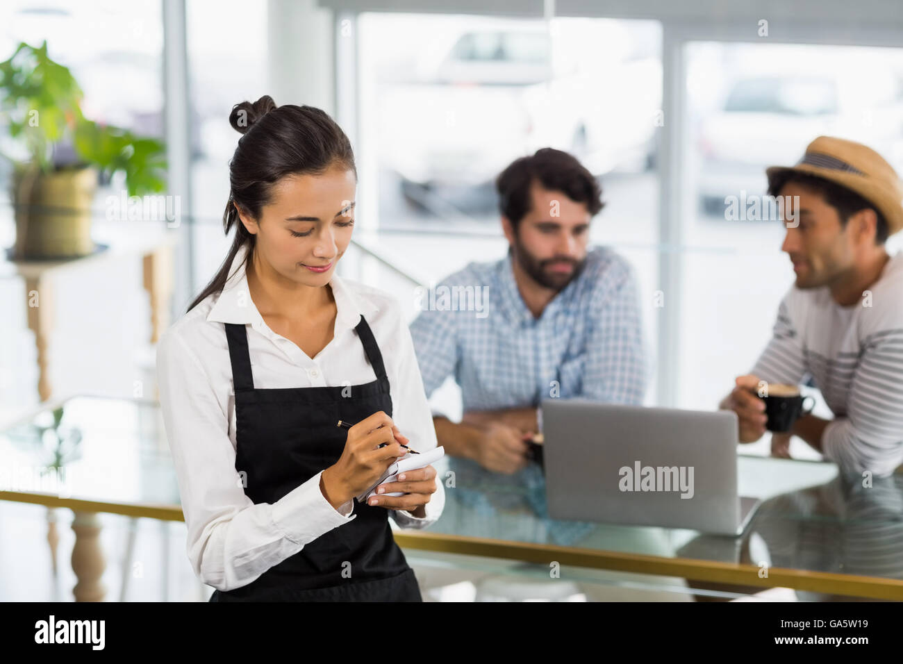 Attractive waitress in apron hi-res stock photography and images - Alamy