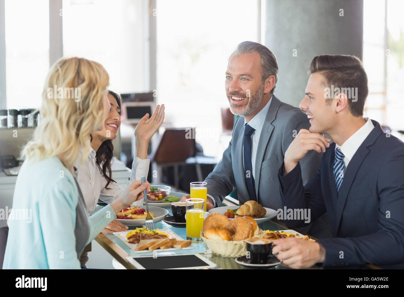 Business people having meal in restaurant Stock Photo - Alamy