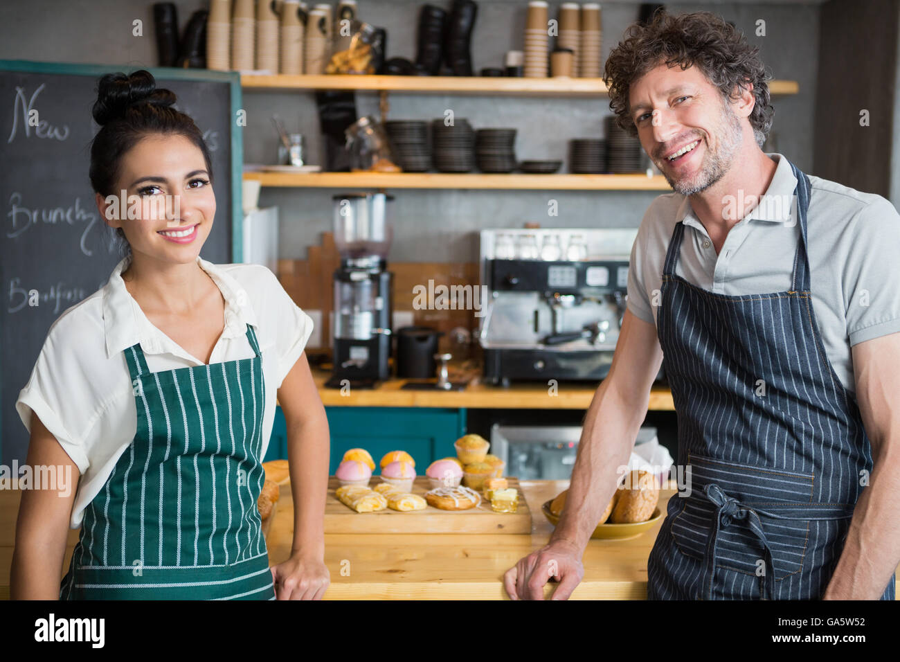 Waiter and waitress standing at counter in cafeteria Stock Photo - Alamy