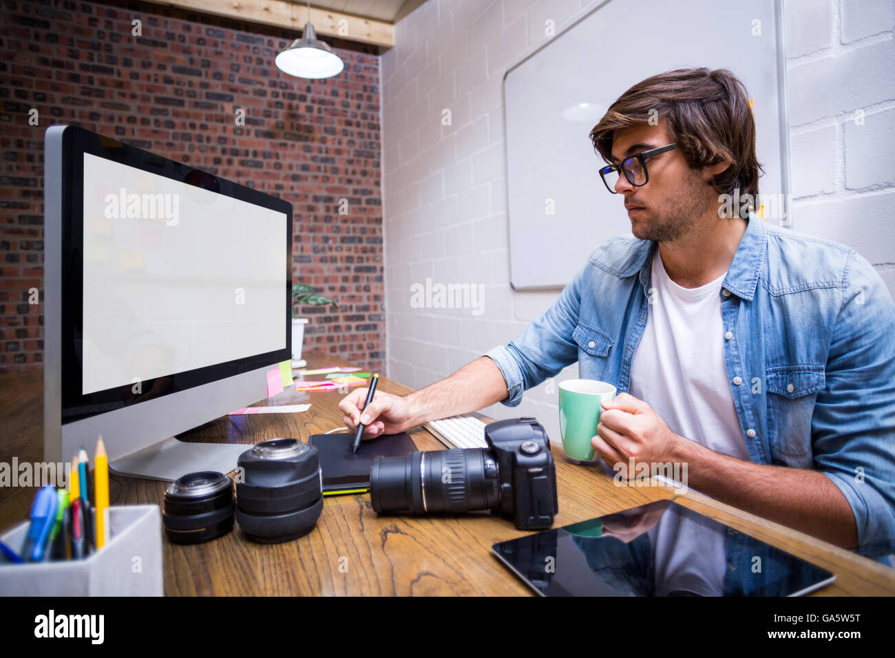 Focused man using computer in office Stock Photo - Alamy