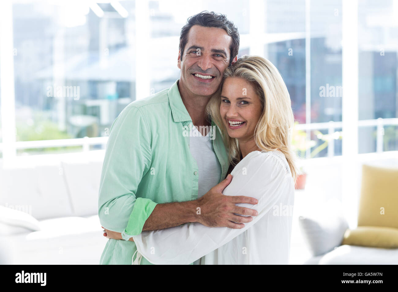 Couple hugging home hi-res stock photography and images - Alamy