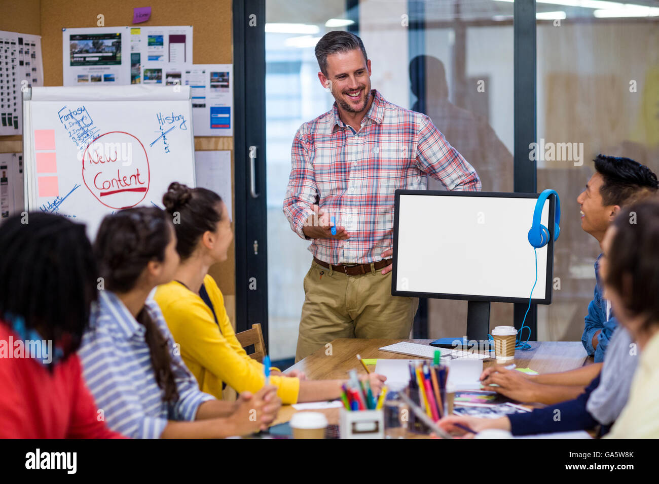 Creative businessman giving presentation to colleagues Stock Photo - Alamy