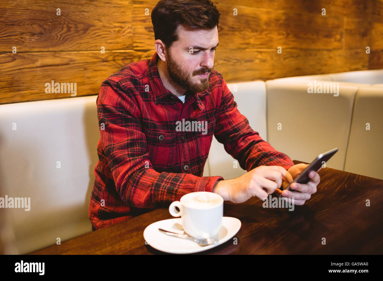 Man using mobile phone at table in restaurant Stock Photo - Alamy