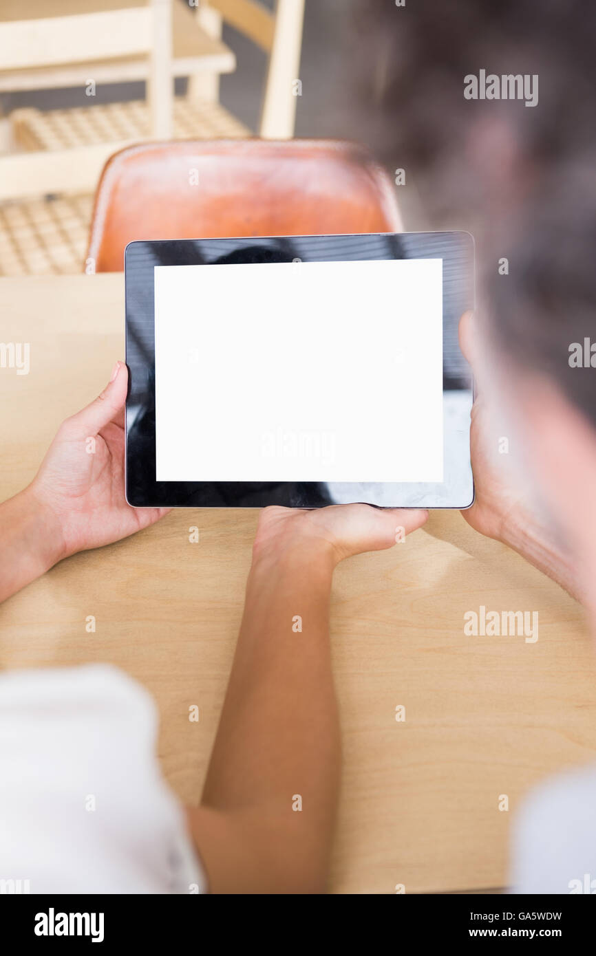 Woman using digital tablet in cafeteria Stock Photo - Alamy