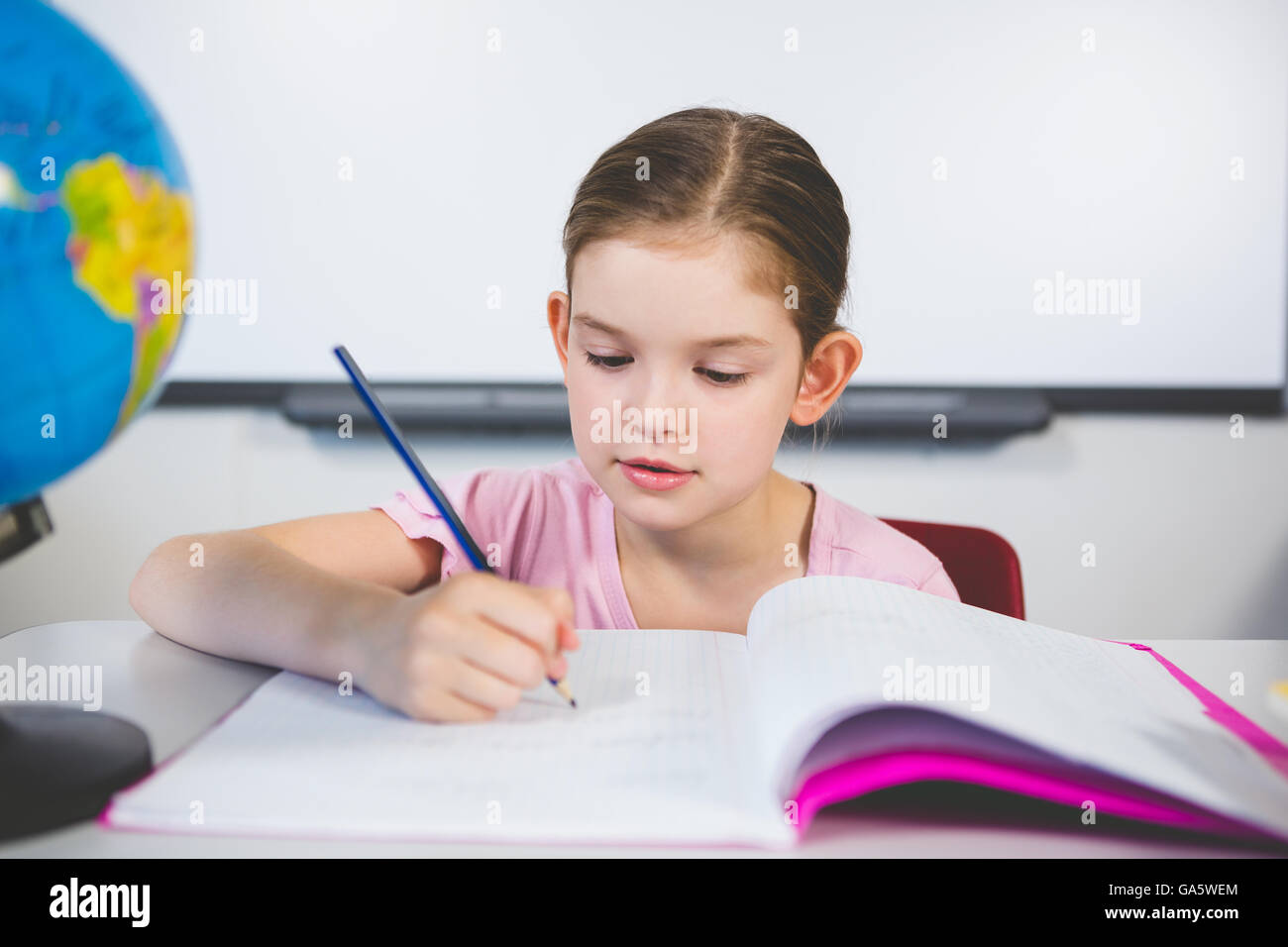Schoolgirl doing homework hi-res stock photography and images - Alamy