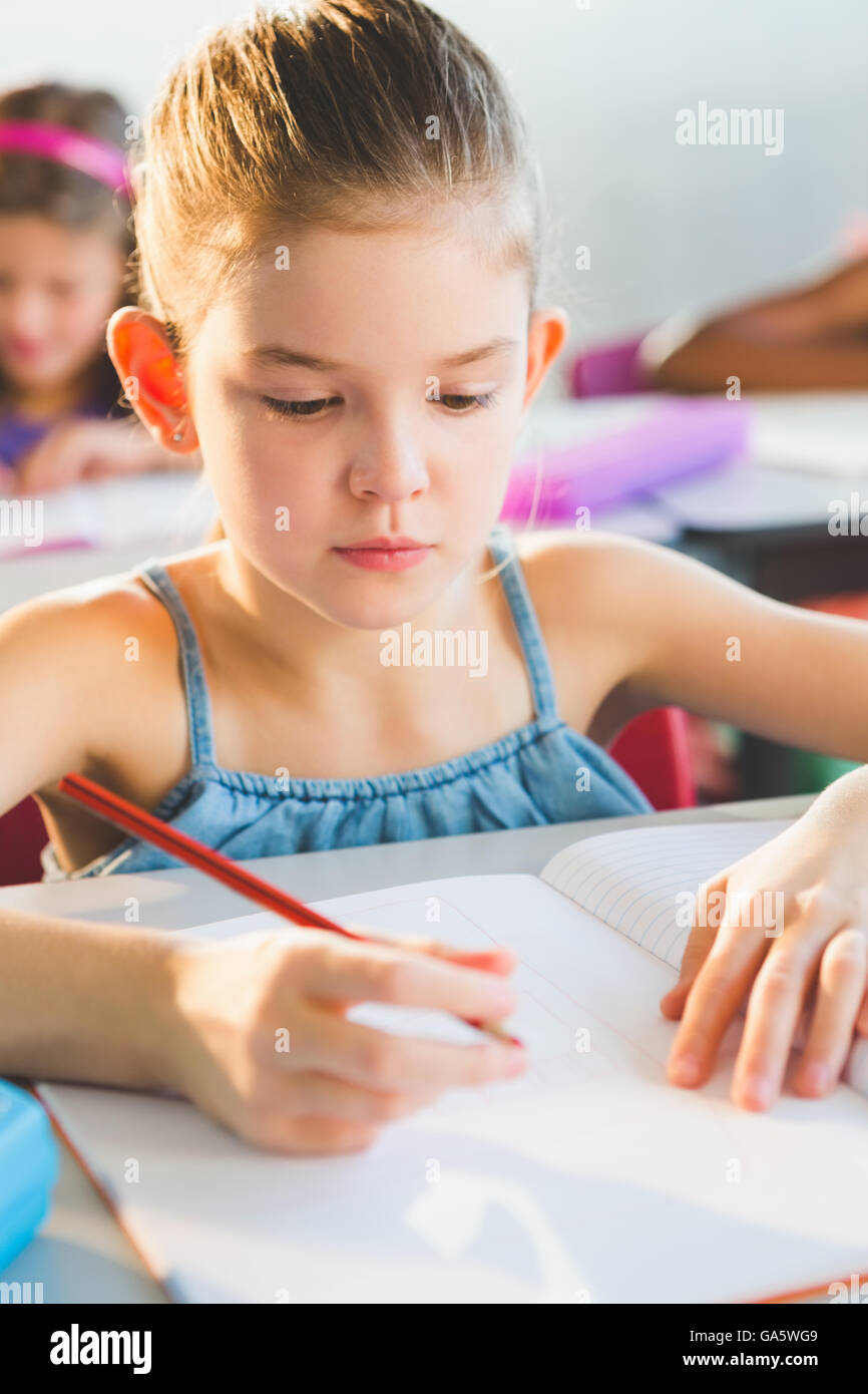 Close-up of schoolkid doing homework in classroom Stock Photo - Alamy