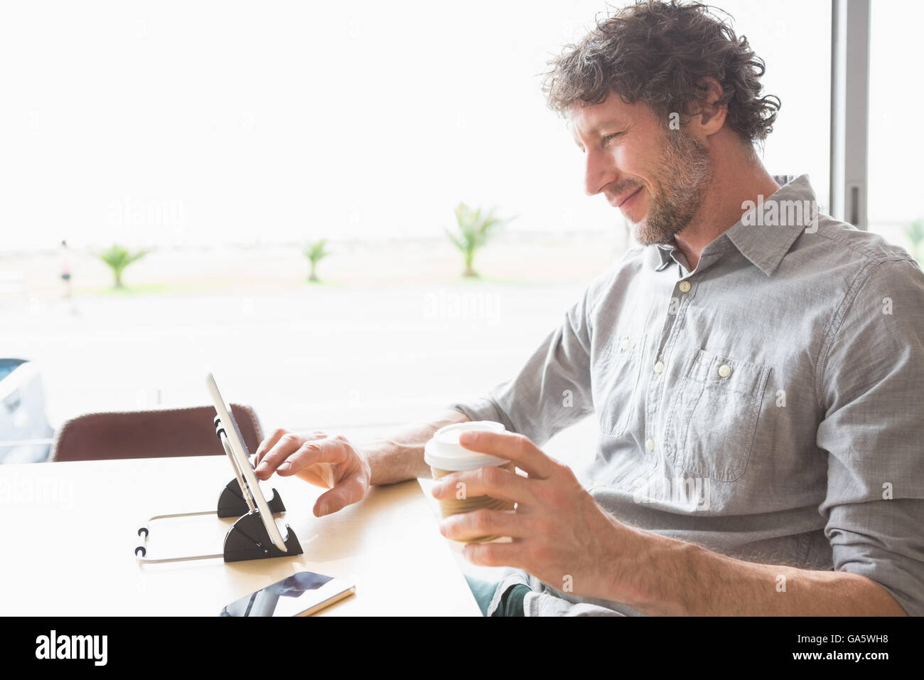 Man using digital tablet Stock Photo - Alamy