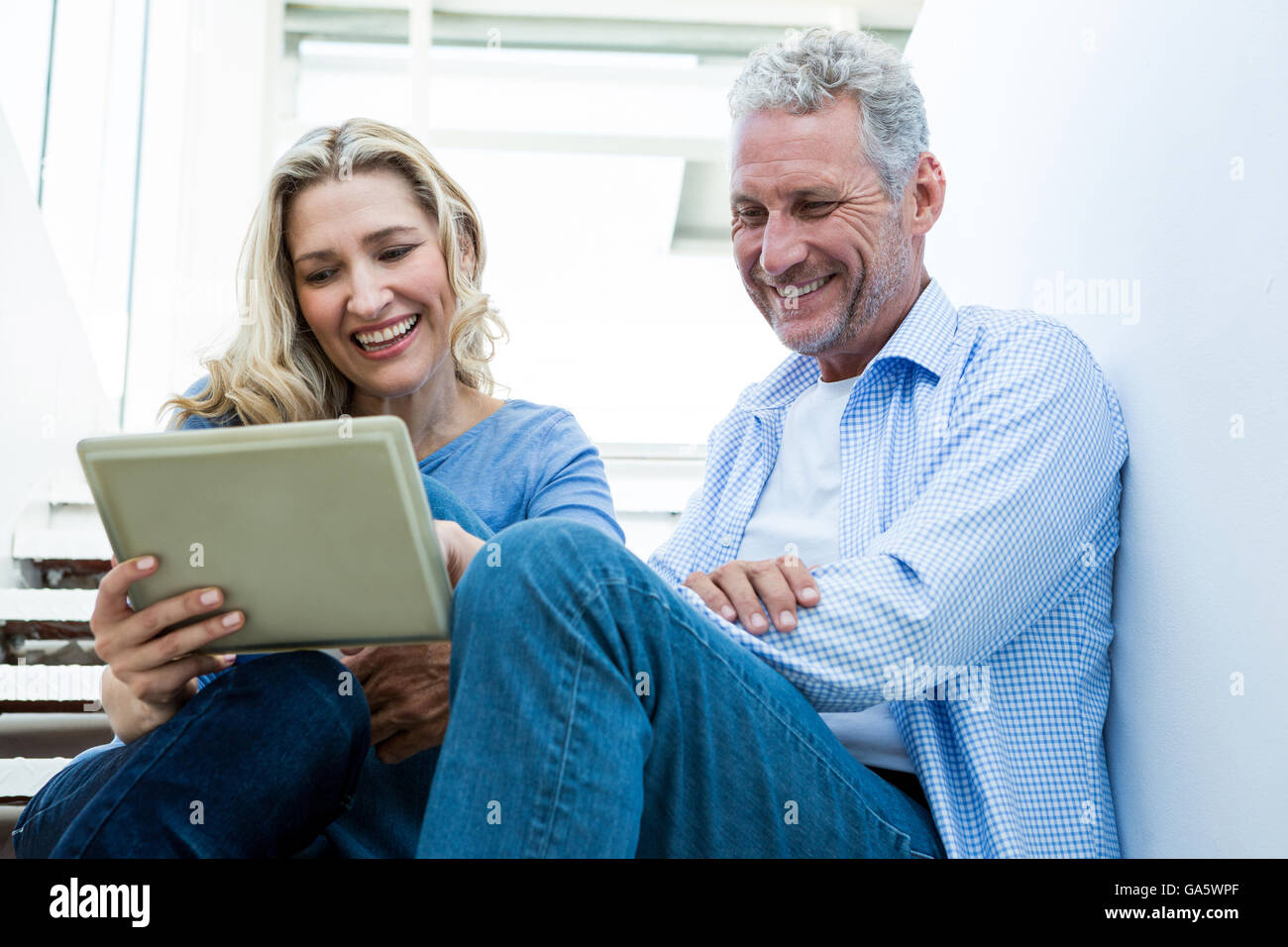 Smiling couple using digital tablet Stock Photo - Alamy