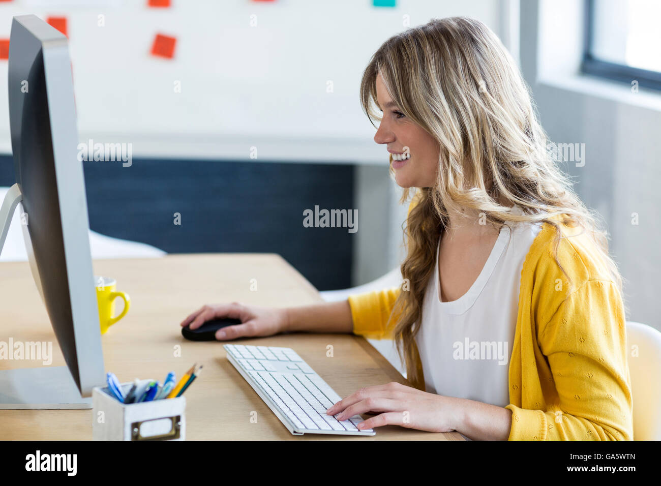 Pretty woman working on computer hi-res stock photography and images ...