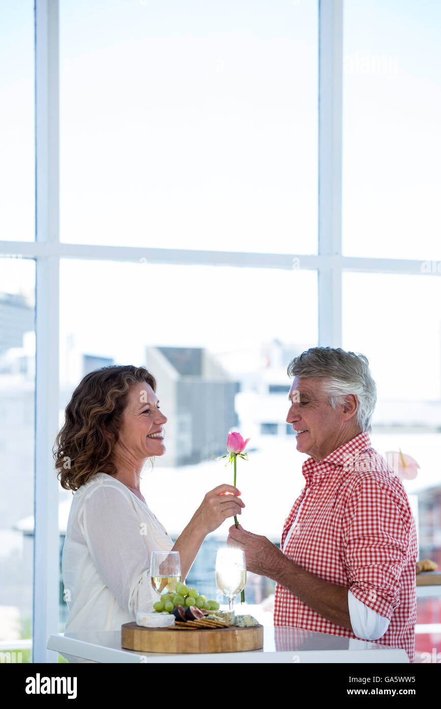 Man giving flower to happy woman Stock Photo - Alamy