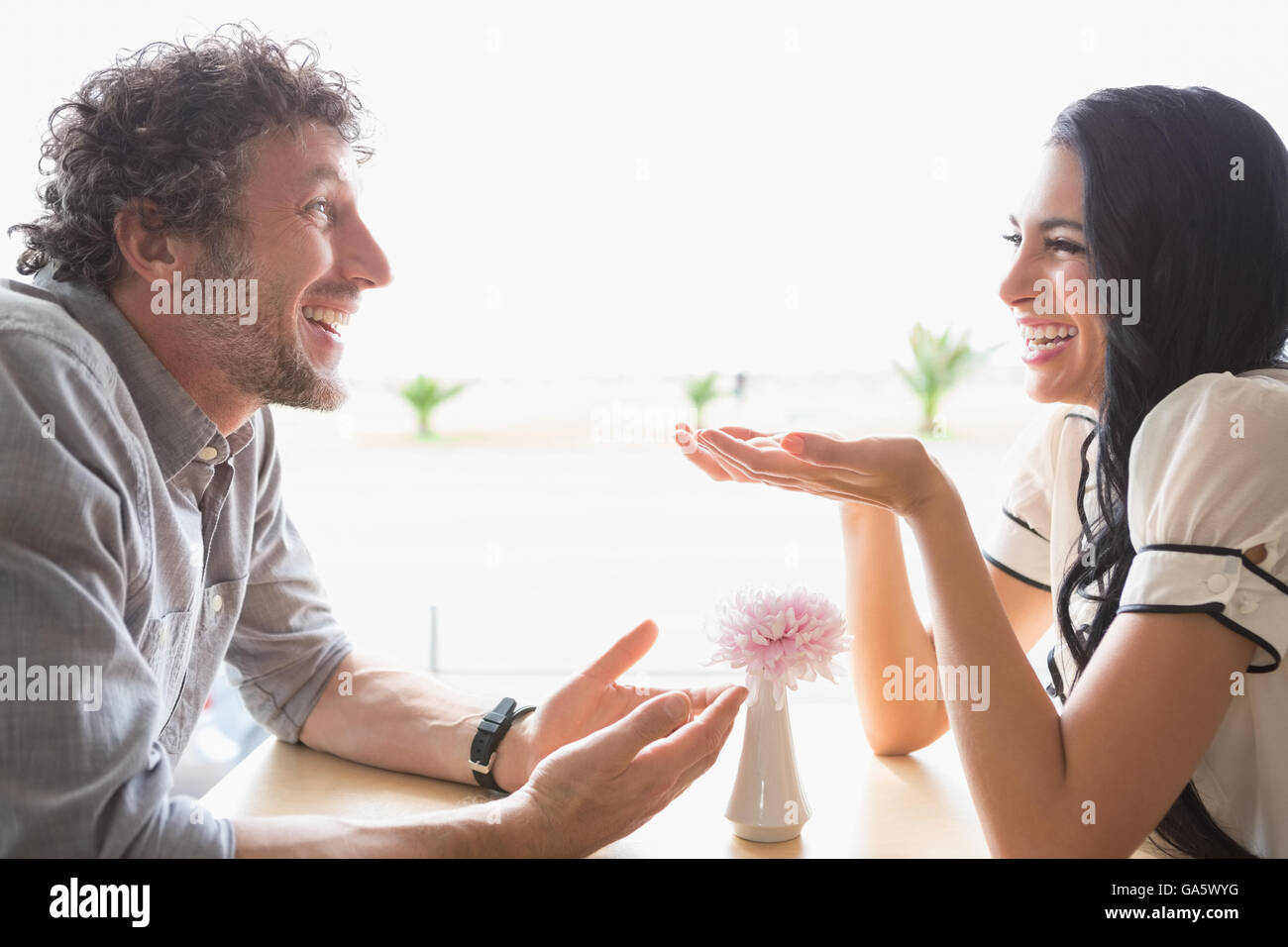 Couple interacting with each other in cafeteria Stock Photo - Alamy