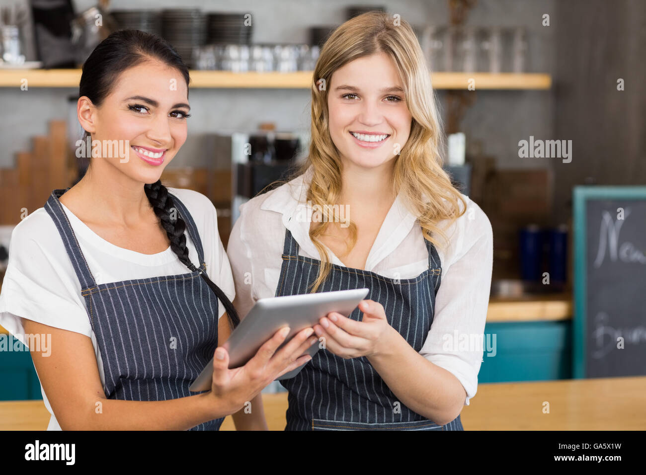 Portrait two smiling waitresses hi-res stock photography and images - Alamy