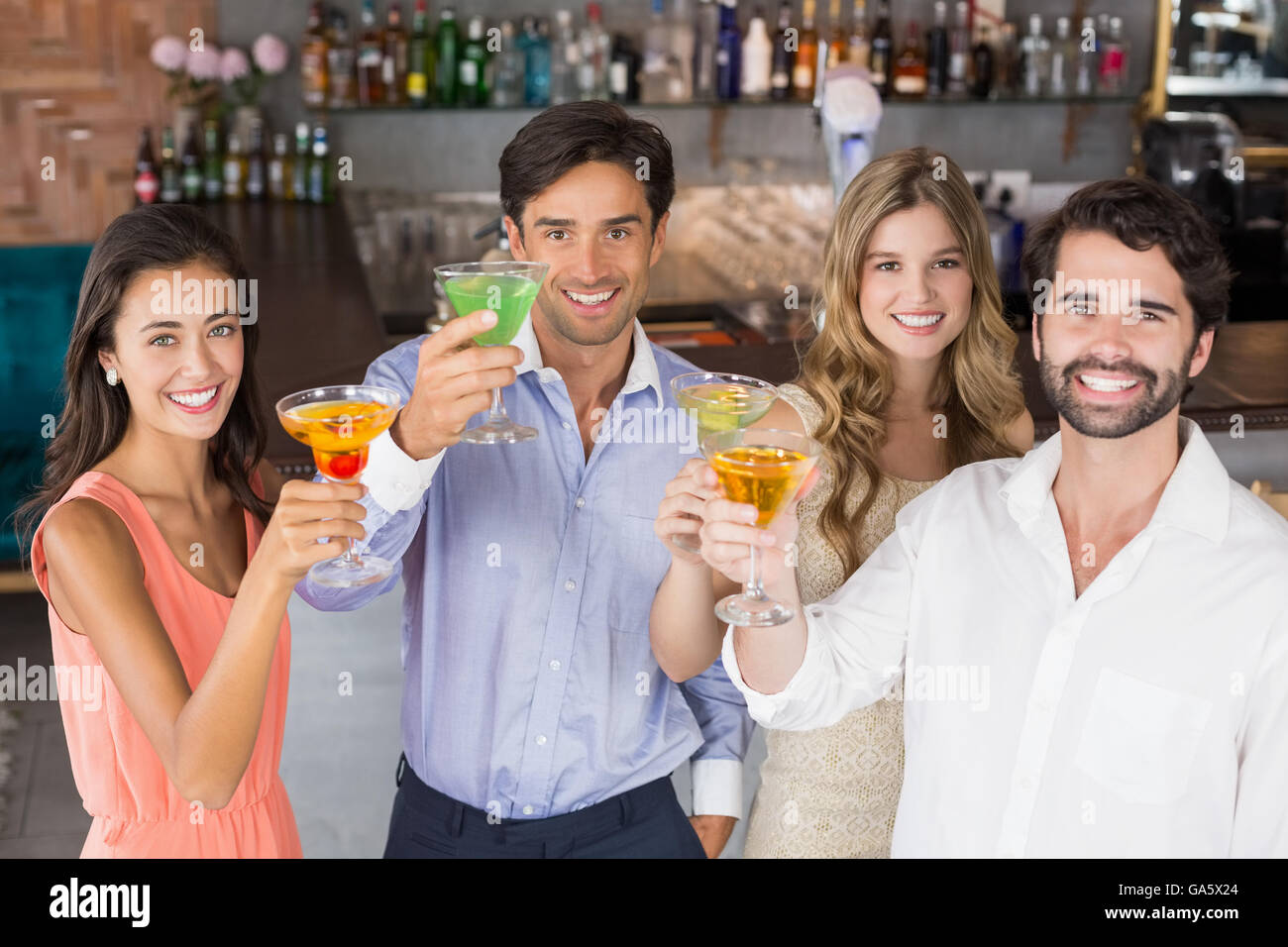 Young friends toasting glasses hi-res stock photography and images - Alamy