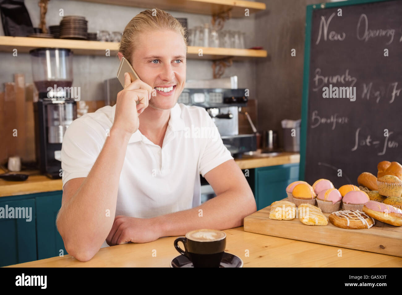 Waiter talking on mobile phone Stock Photo - Alamy
