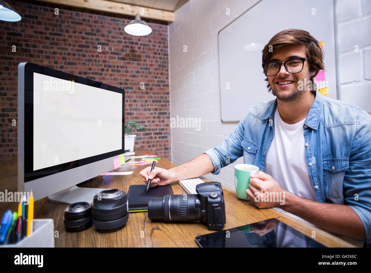 Portrait of smiling graphic designer working in office Stock Photo - Alamy
