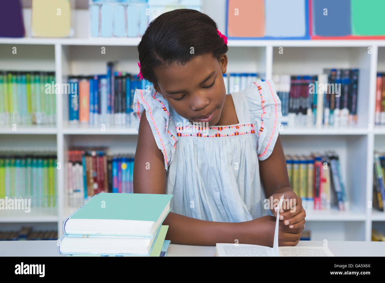 Schoolgirl reading book table school hi-res stock photography and ...