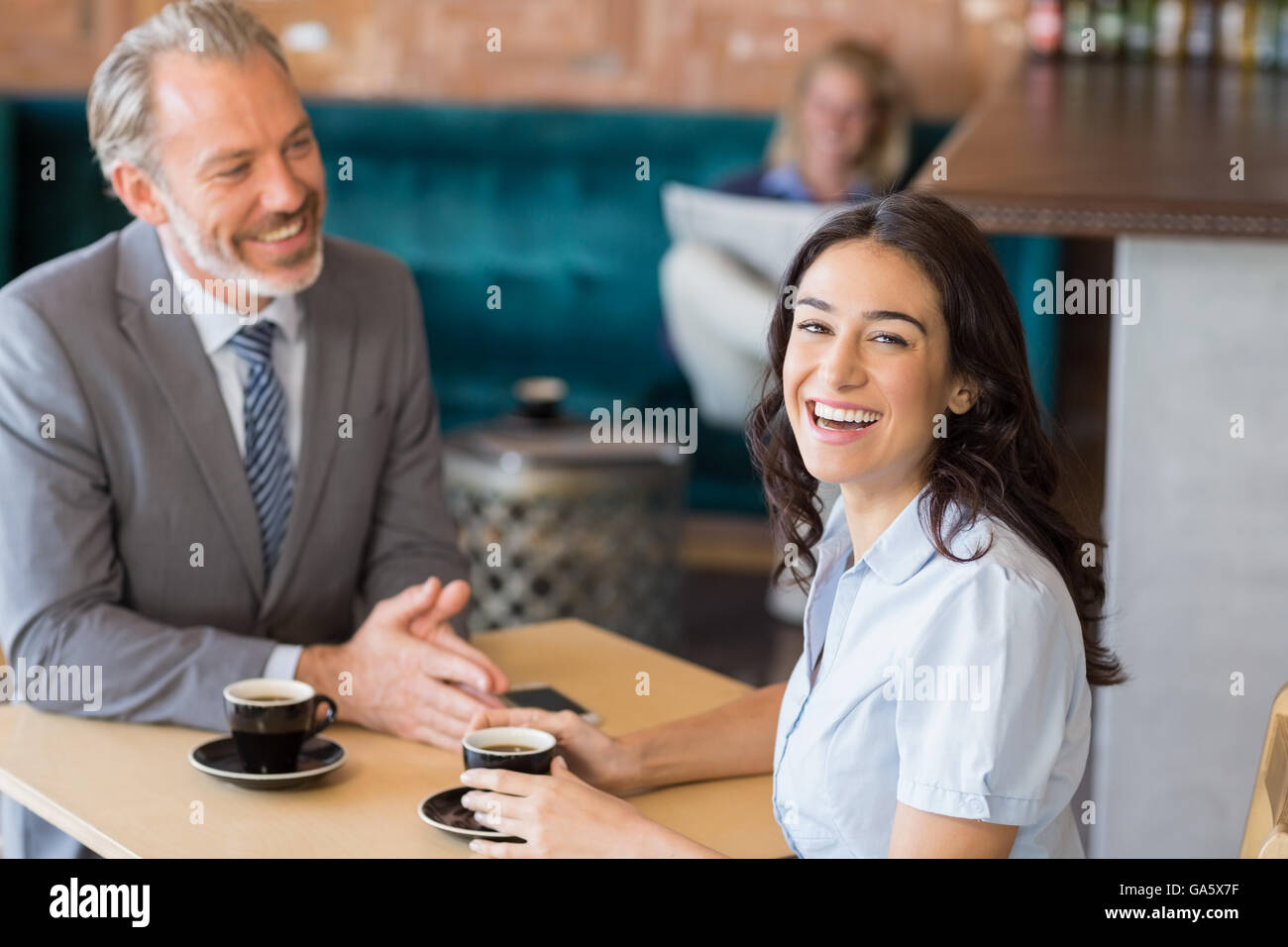 Business colleagues interacting other having hi-res stock photography ...