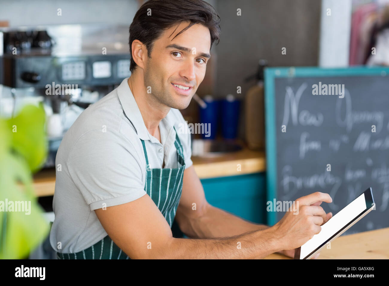 Portrait of waiter using digital tablet Stock Photo - Alamy