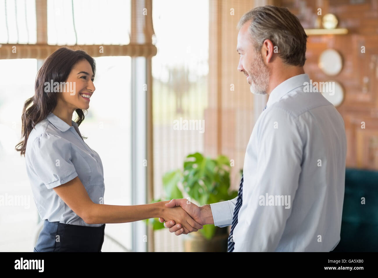 Caucasian woman shaking hands hi-res stock photography and images - Alamy