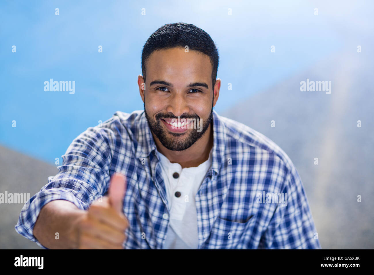 Businessman gesturing thumbs up in office Stock Photo - Alamy