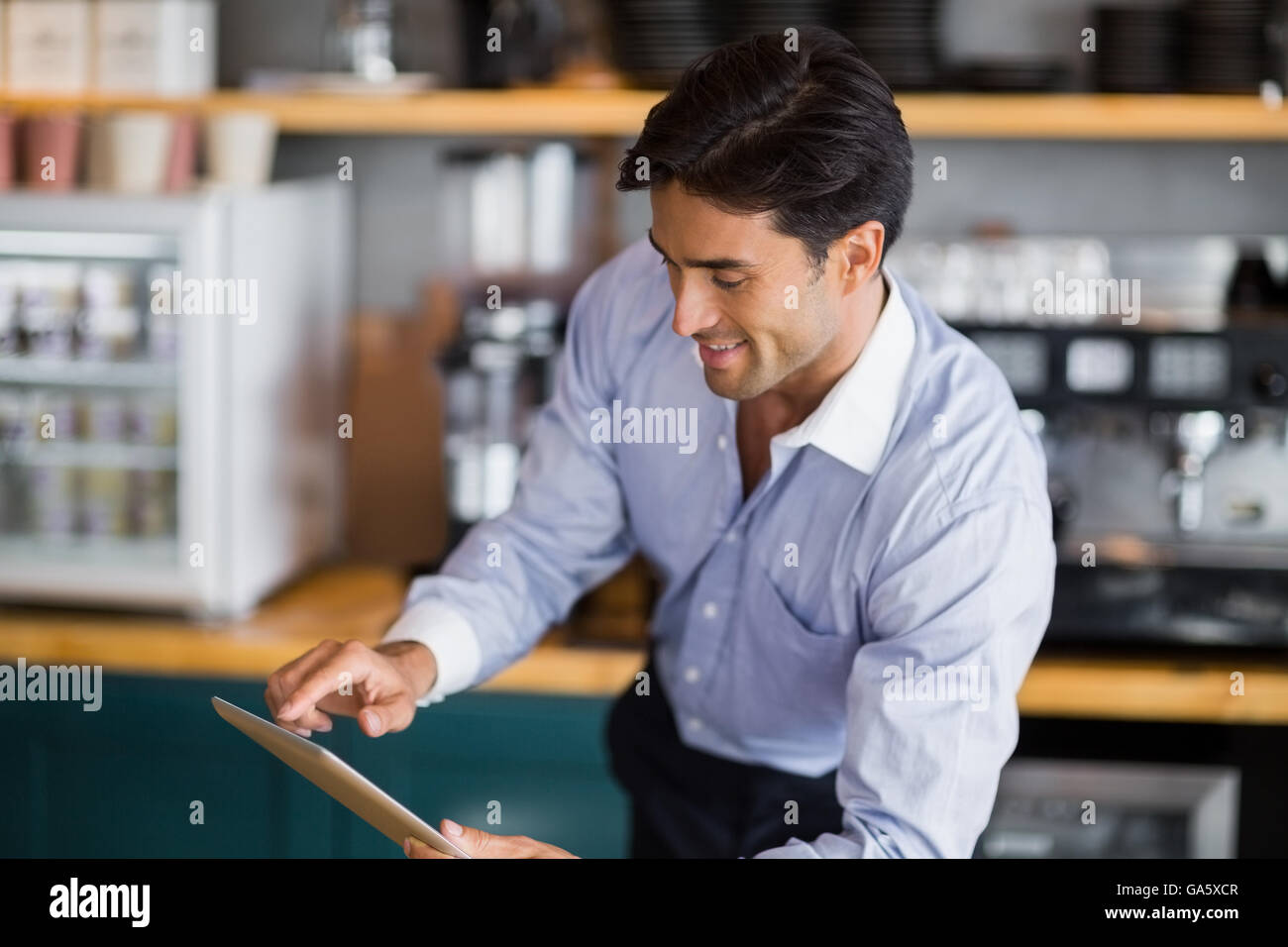 Smiling man using digital tablet Stock Photo - Alamy