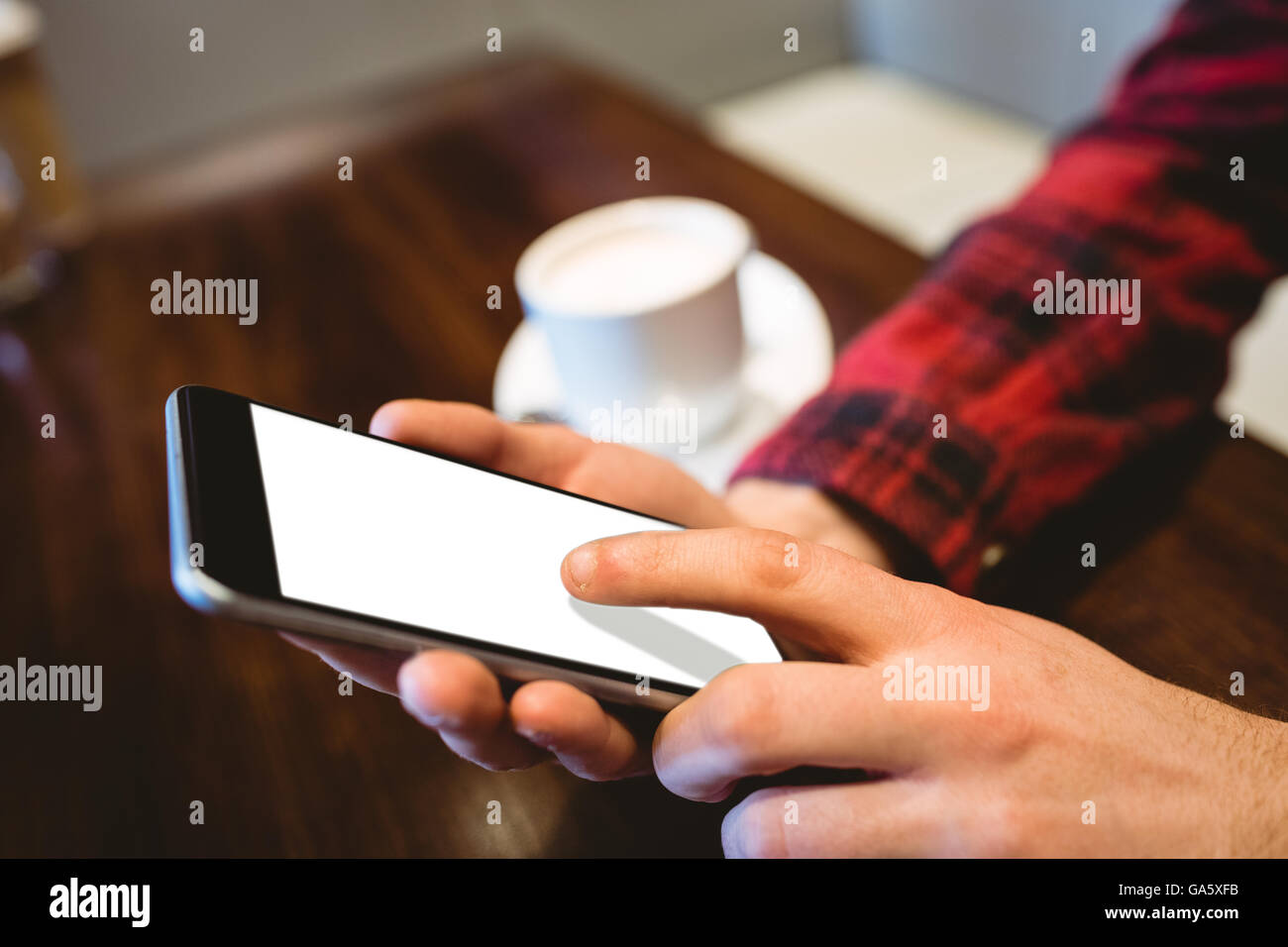 Person using mobile phone at table in restaurant Stock Photo - Alamy