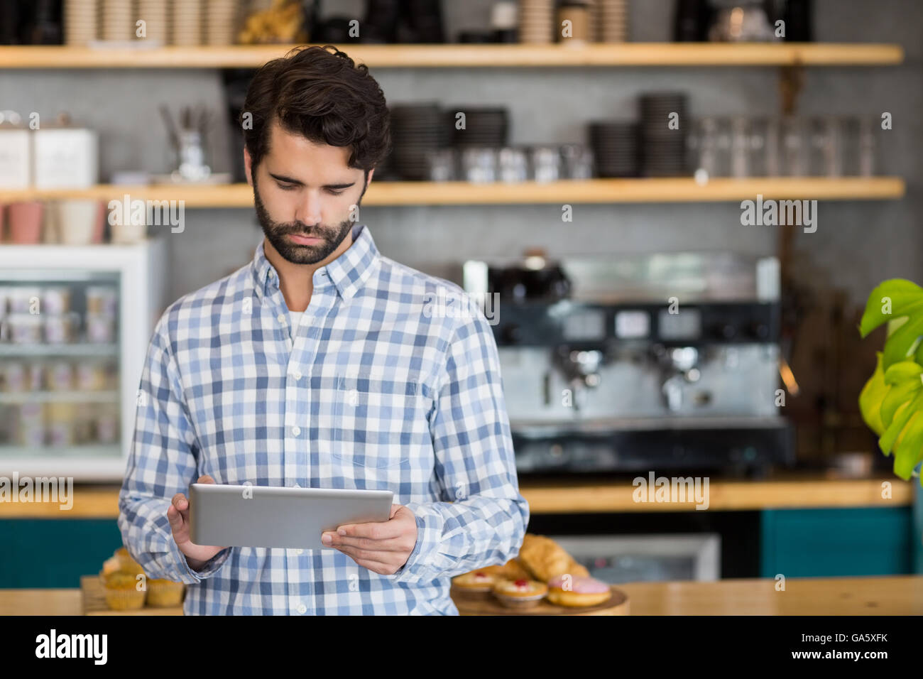 Man using digital tablet at cafe Stock Photo - Alamy