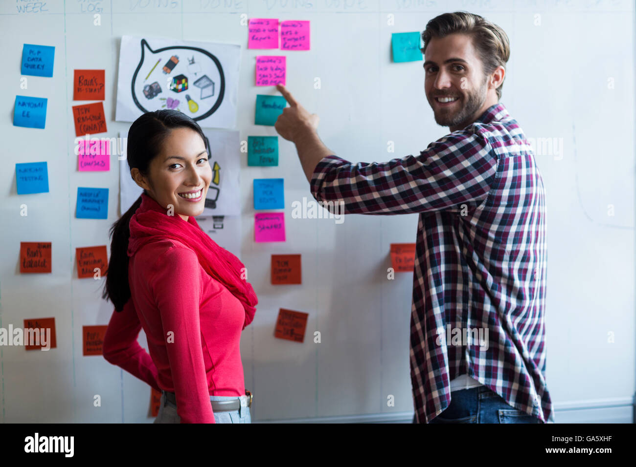 Portrait of colleagues with sticky notes in office Stock Photo - Alamy