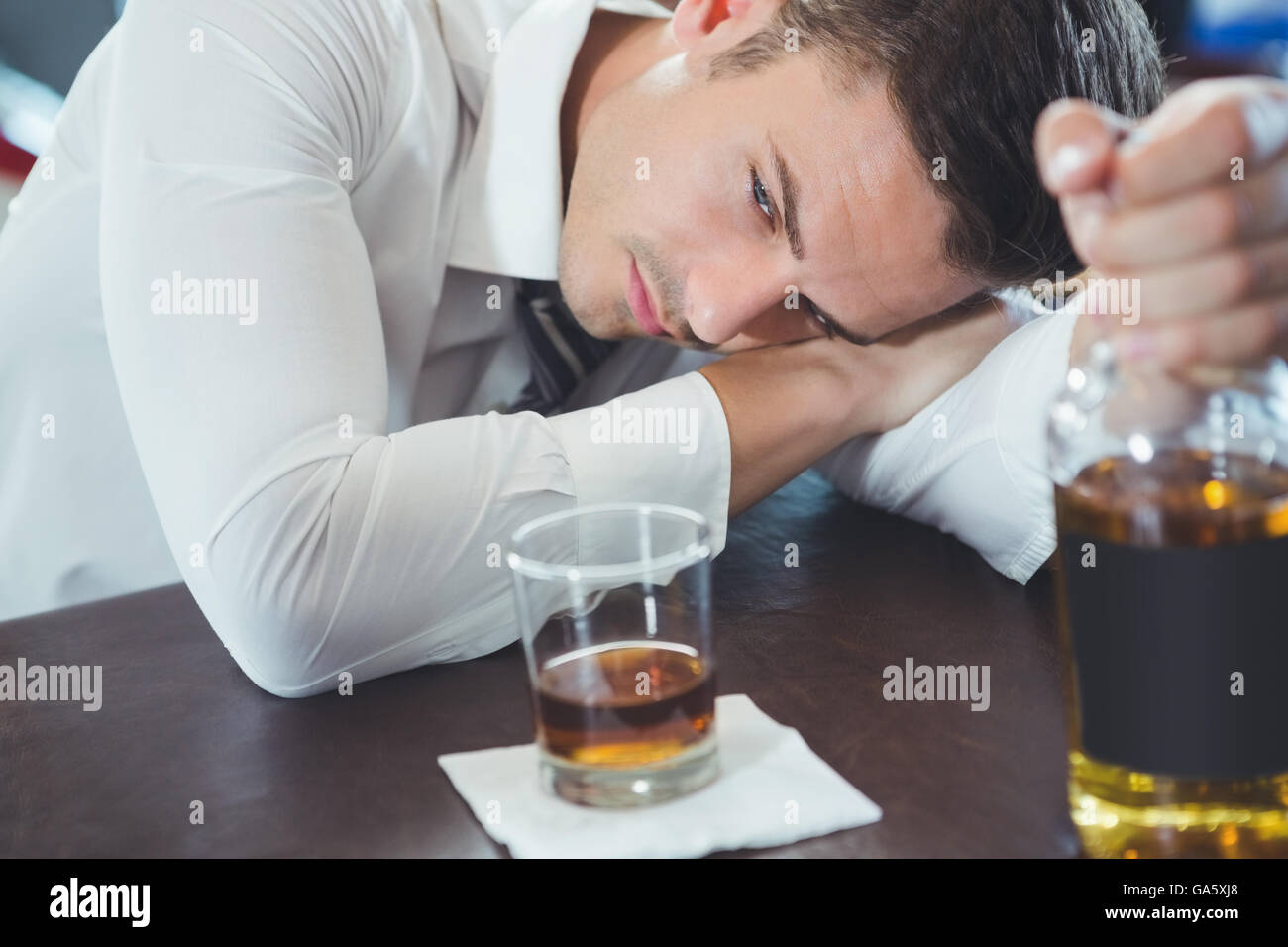 Drunken man lying on a bar counter Stock Photo - Alamy