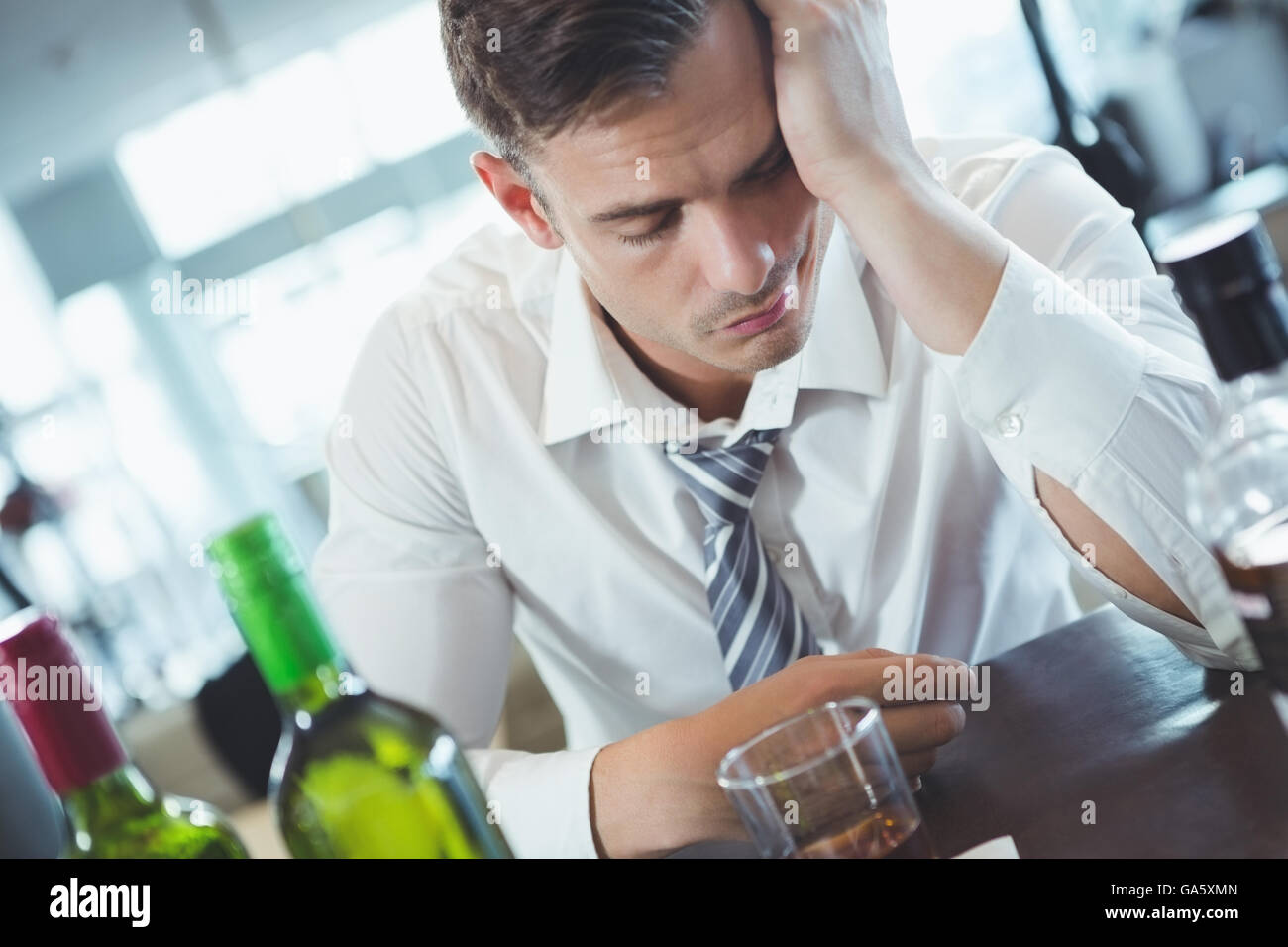 Young man sitting on bar hi-res stock photography and images - Alamy