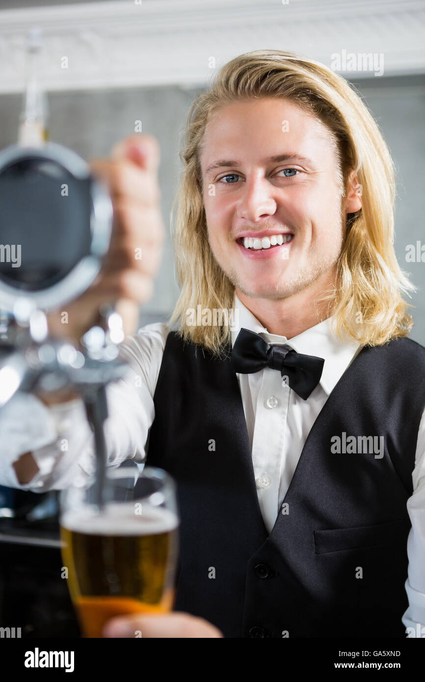 Waiter filling beer from bar pump Stock Photo - Alamy